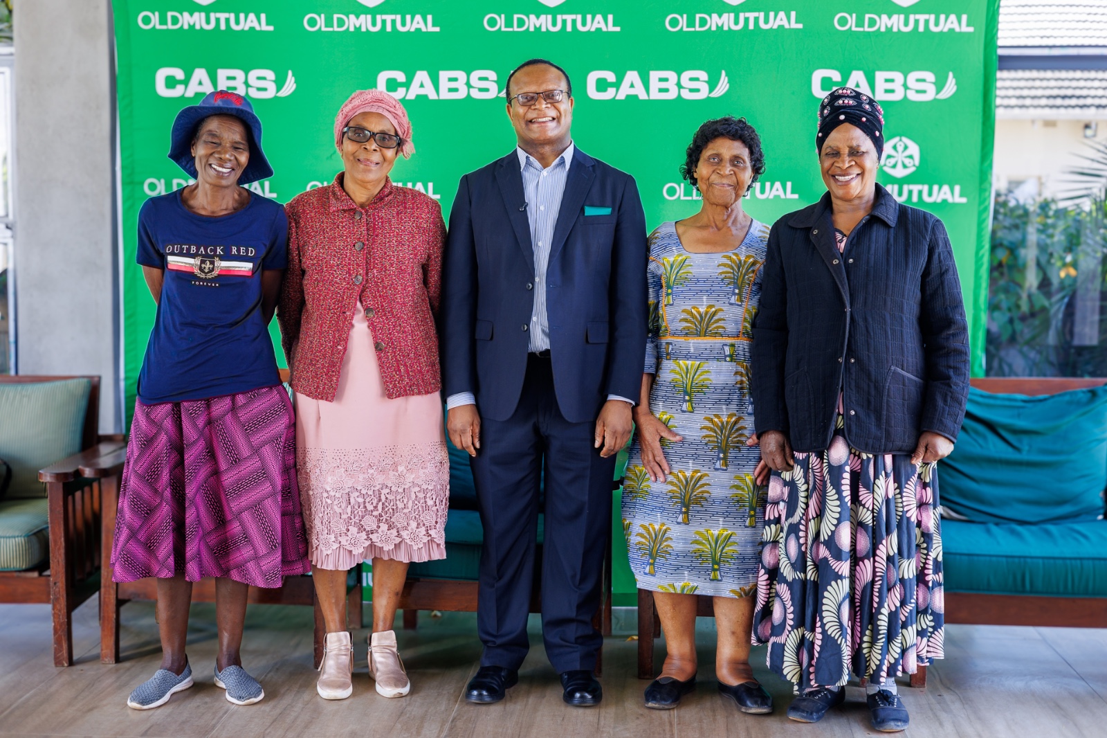 Old Mutual Zimbabwe Group CEO Sam Matsekete with beneficiaries of the ...
